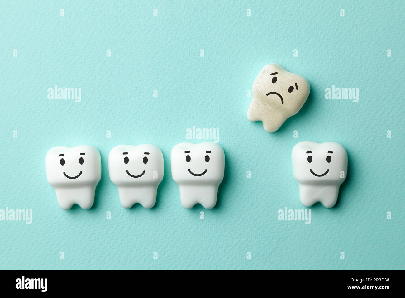 Healthy white teeth are smiling and removing yellow tooth with caries ...