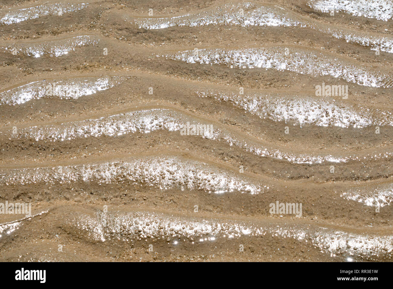 Wave on fine sand when the sea is ebb tide Stock Photo - Alamy