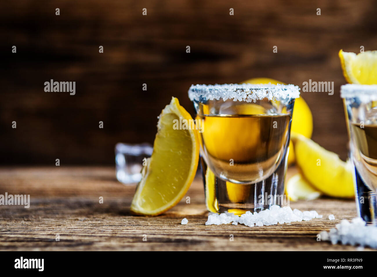 Mexican traditional alcohol drink Tequila with lemons and salt and ice ...
