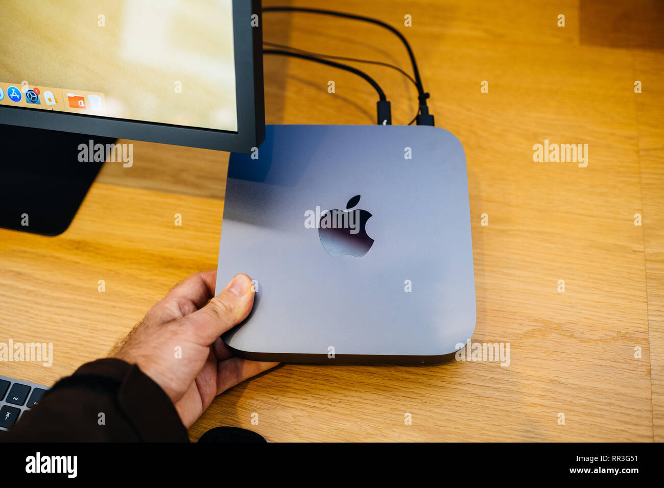 PARIS, FRANCE - NOV 7, 2018: male hand holding new Apple Mac Mini ...