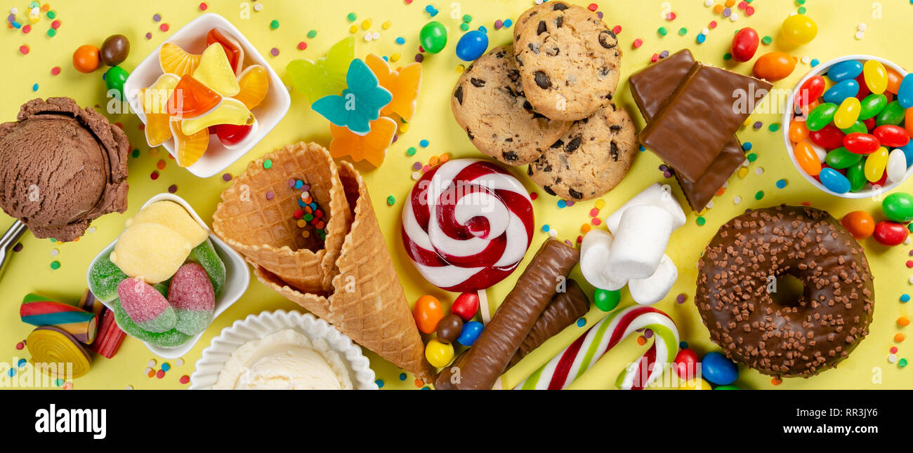 Selection of colorful sweets - chocolate, donuts, cookies, lollipops ...