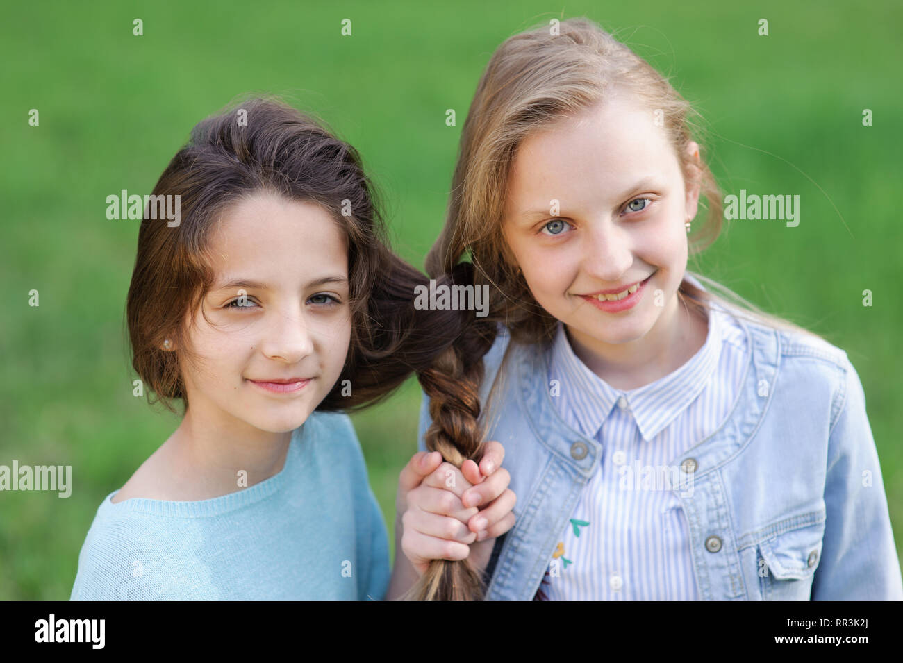 concept of friendship two beautiful girls with connected hairs Stock ...