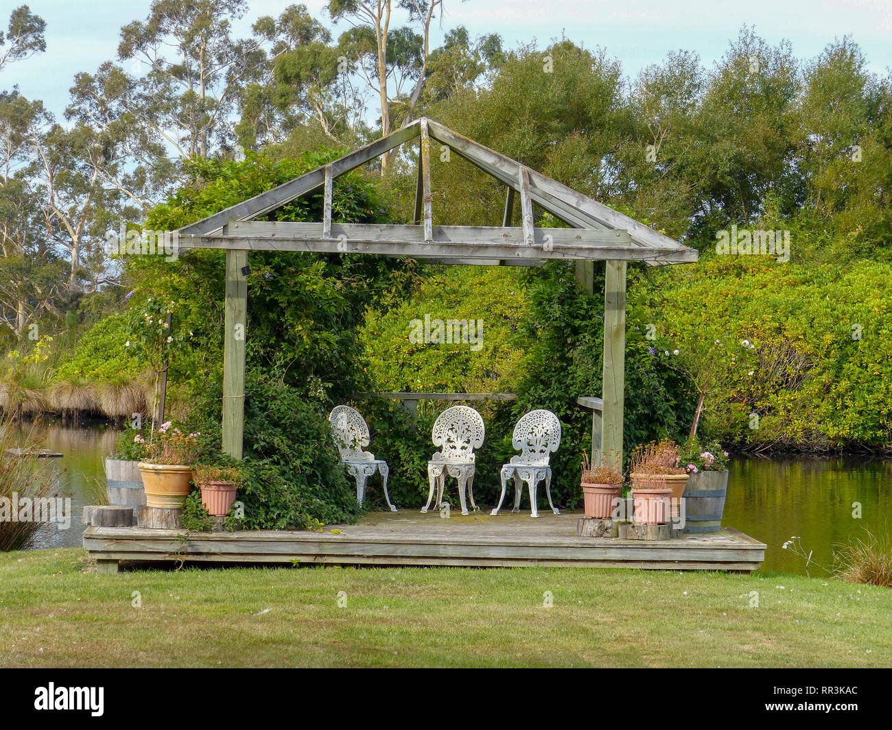 water pond and bench in a remote farm, South Island, New Zealand Stock ...