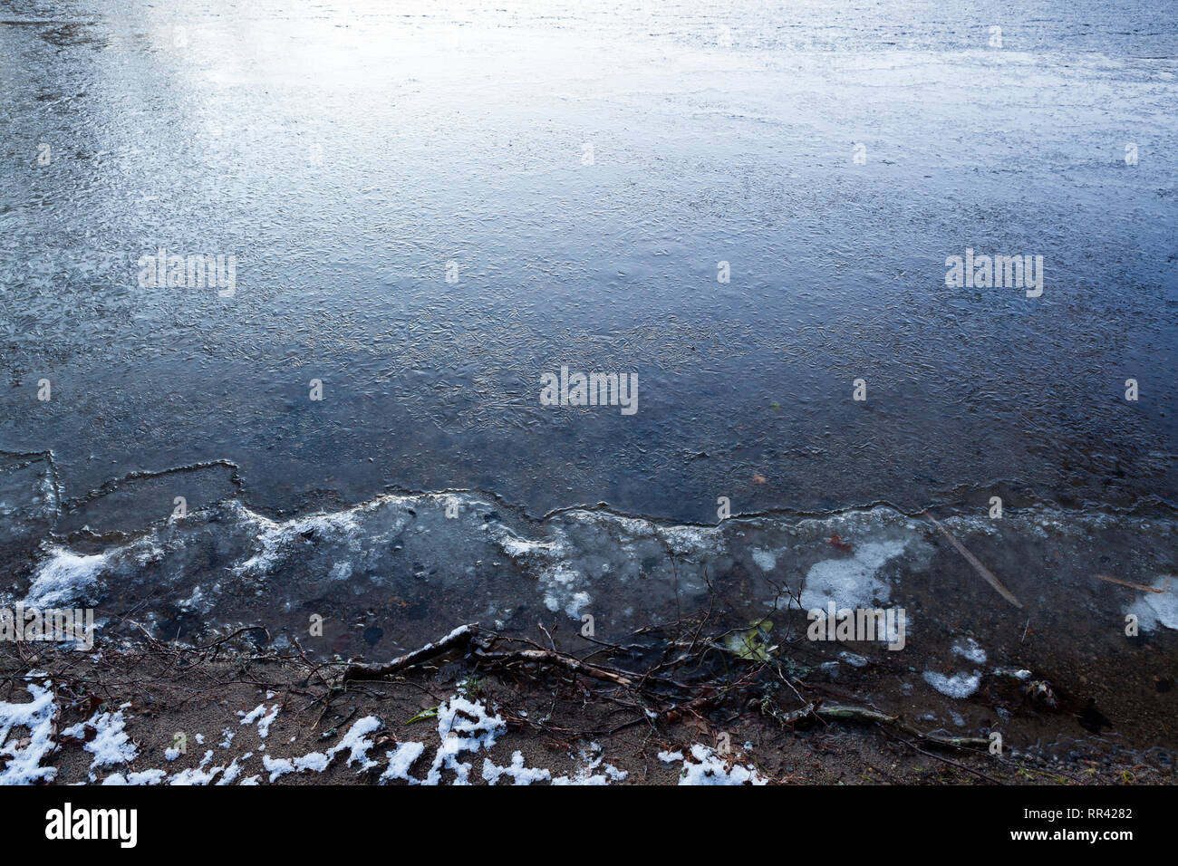 Thin ice on lake water surface Stock Photo - Alamy