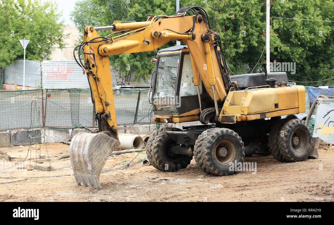 wheeled excavator on ground at day Stock Photo - Alamy