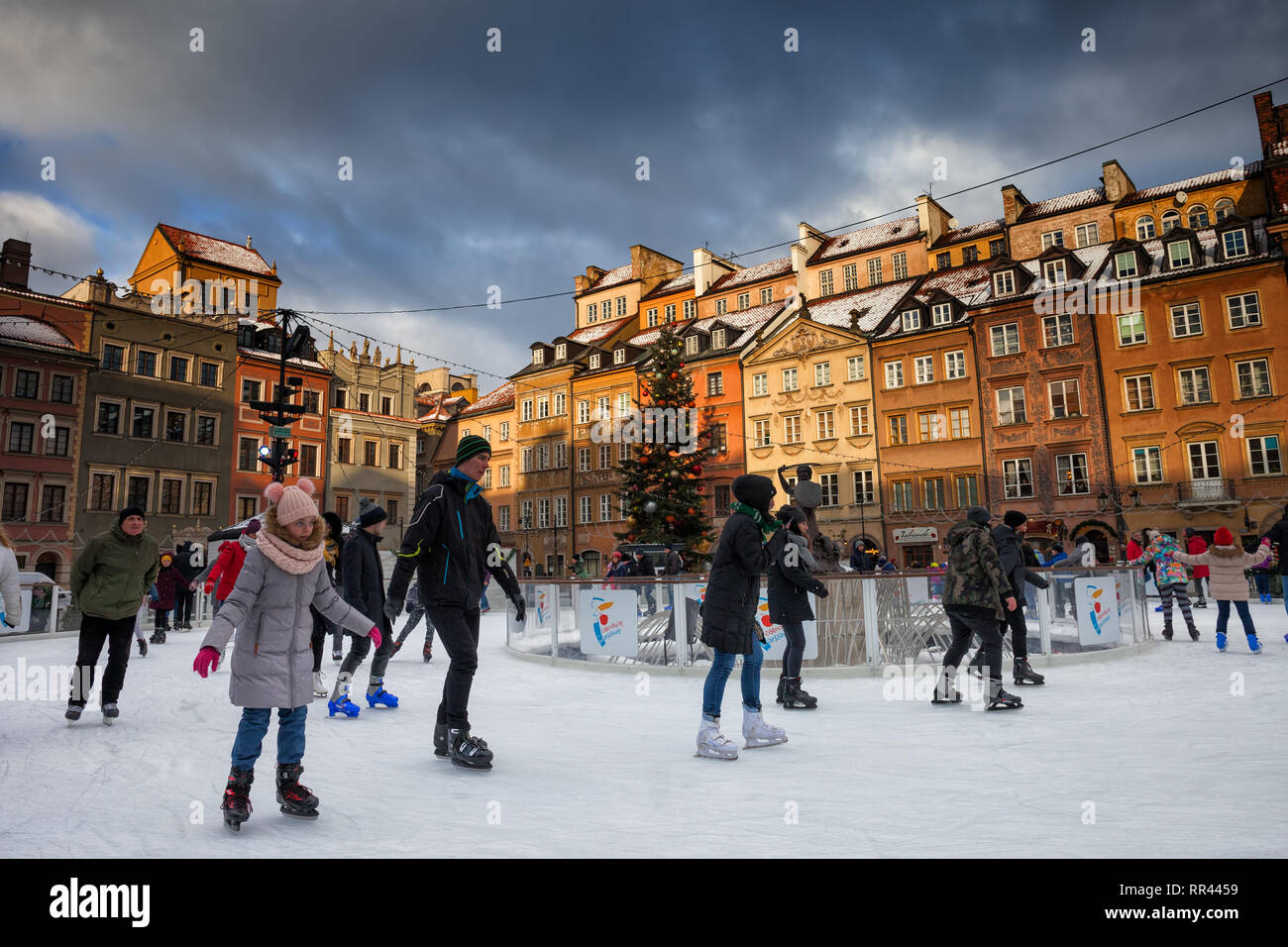 Poland, city of Warsaw, people skating on ice rink at Old Town Market ...