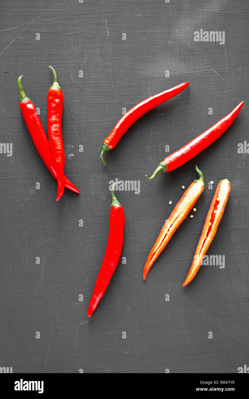 Top view, hot red chili peppers on black background. From above, flat ...