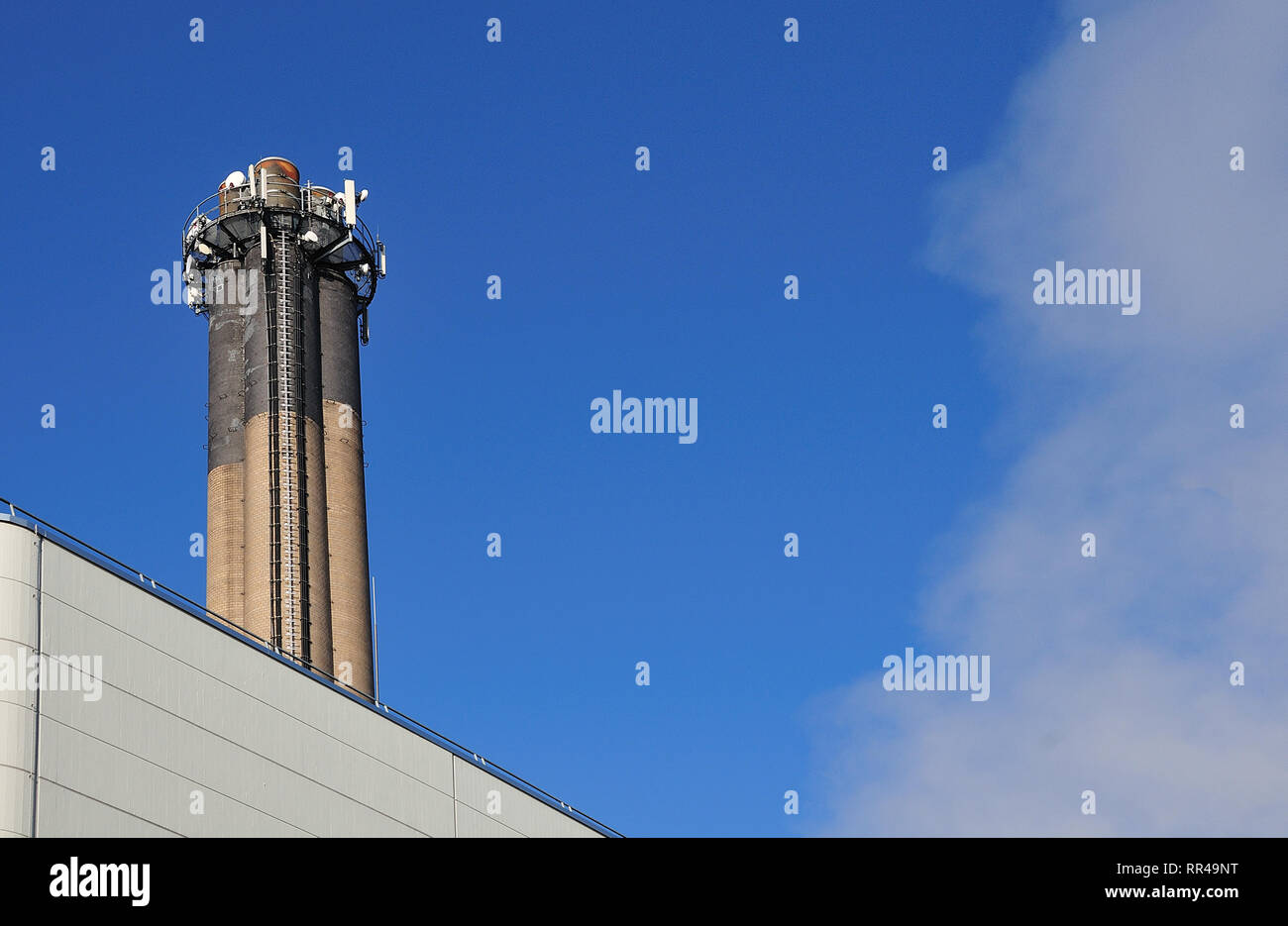 chimney of a waste-to-energy plant with metal ladder outside and ...