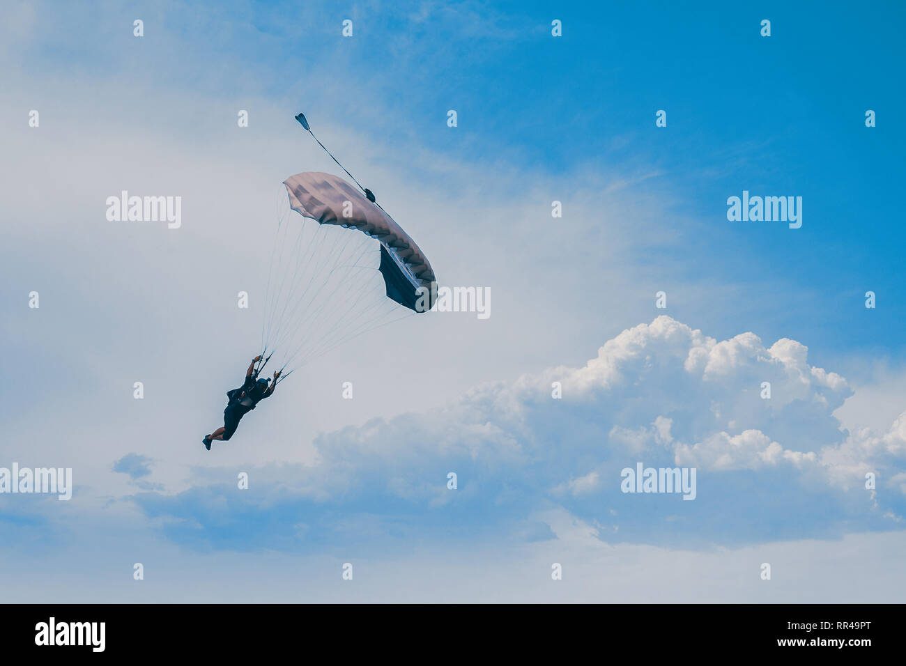 Parachutist falling from the sky in evening sunset dramatic sky ...