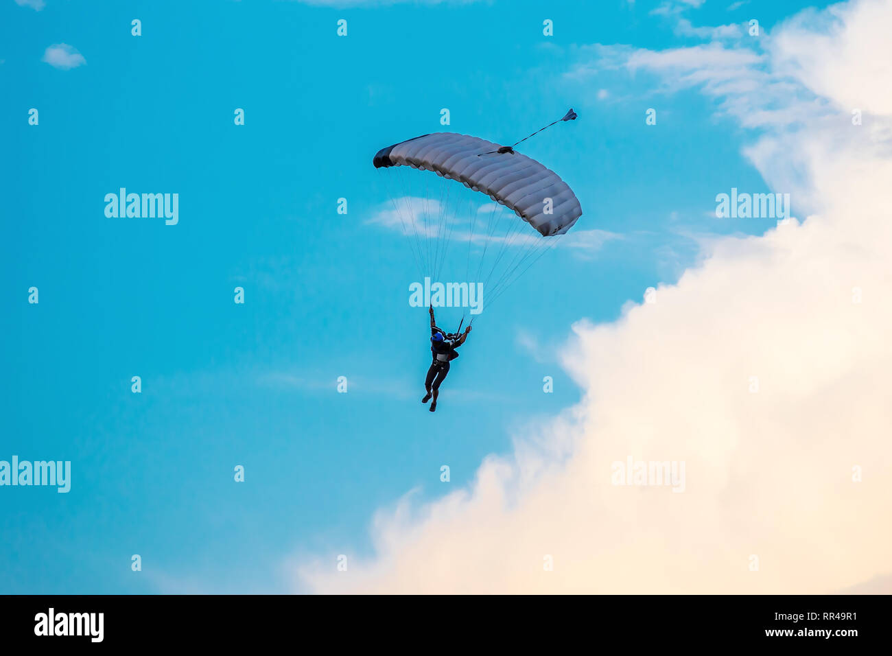 Parachutist falling from the sky in evening sunset dramatic sky ...