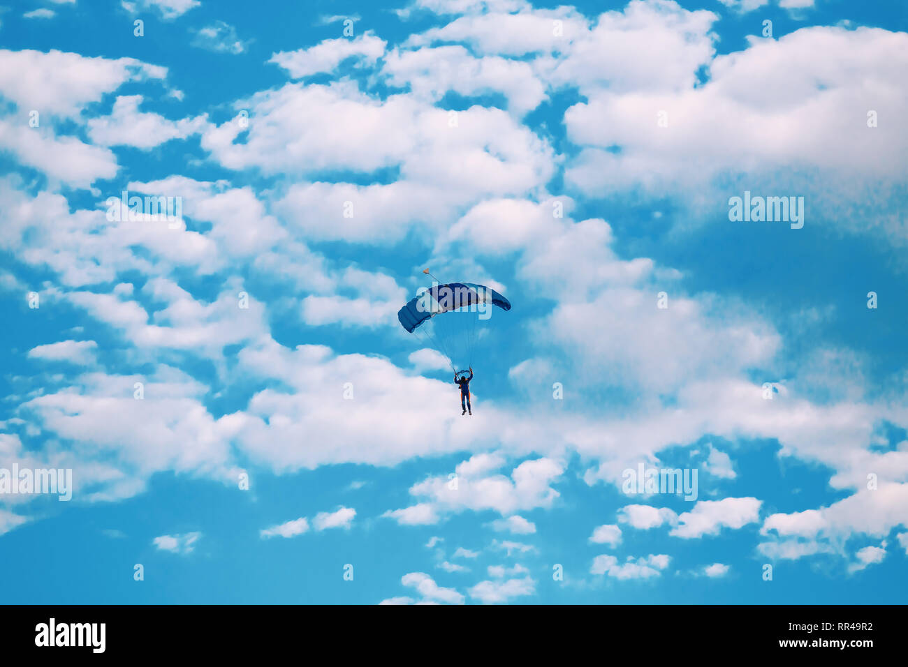 Parachutist falling from the sky in evening sunset dramatic sky ...