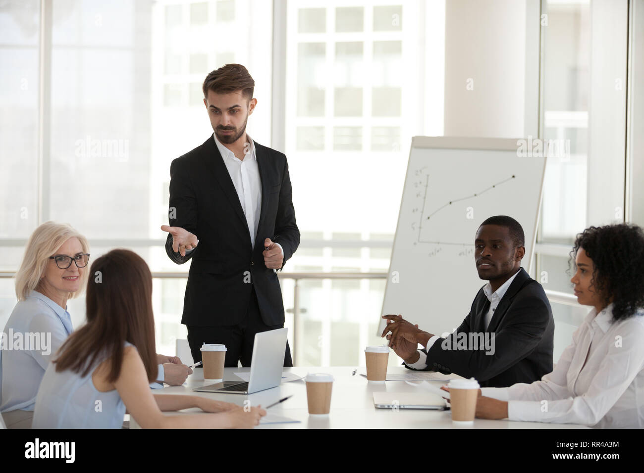 Team leader communicating with company staff during presentation Stock ...