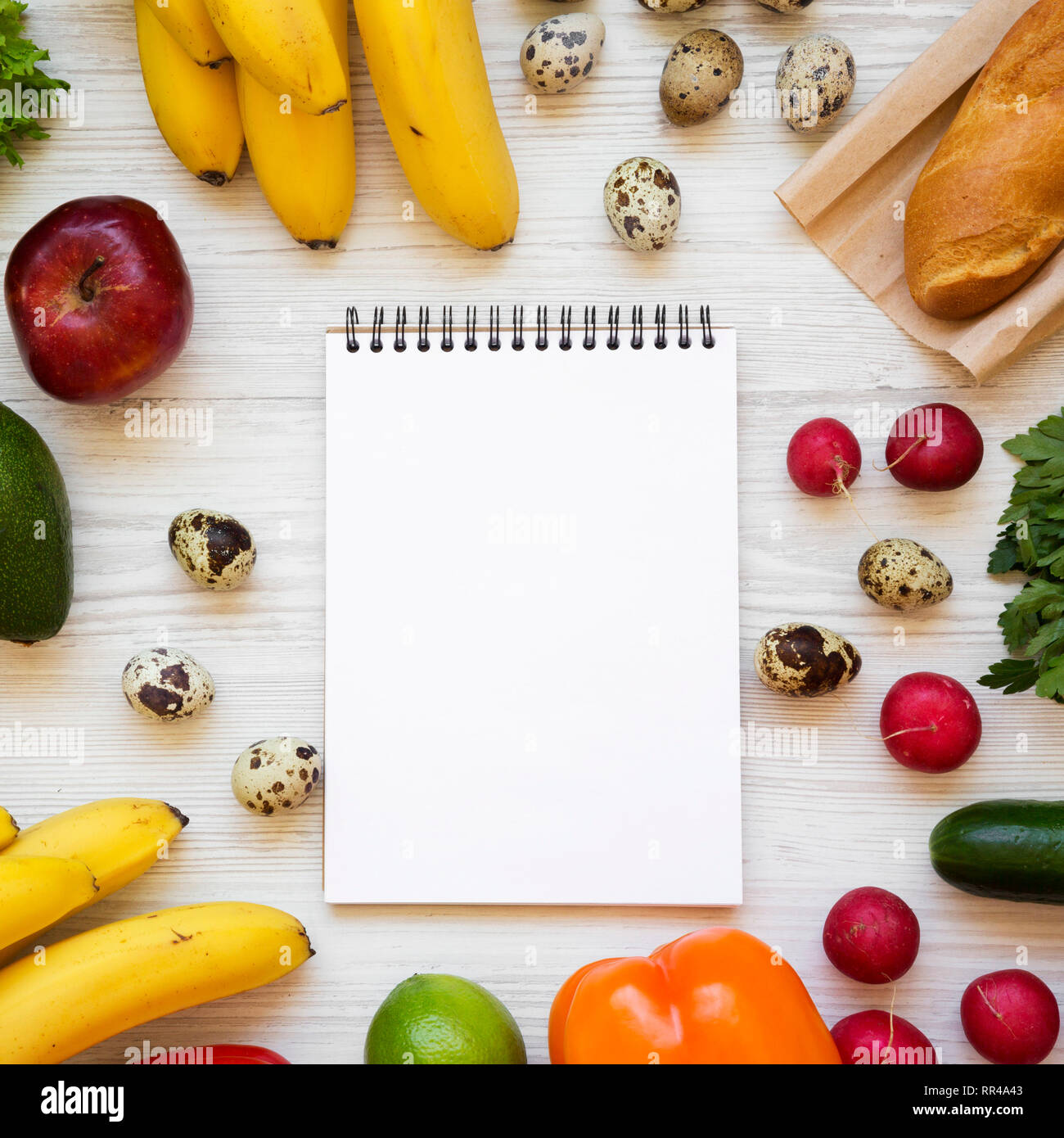 Healthy food concept. Healthy food with blank notepad on a white wooden ...