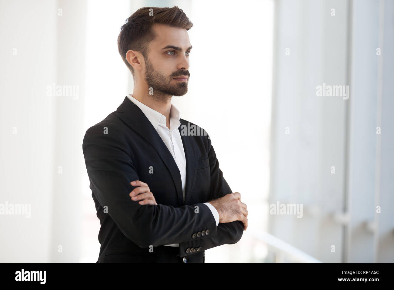 Confident serious company owner thinking looking away Stock Photo - Alamy