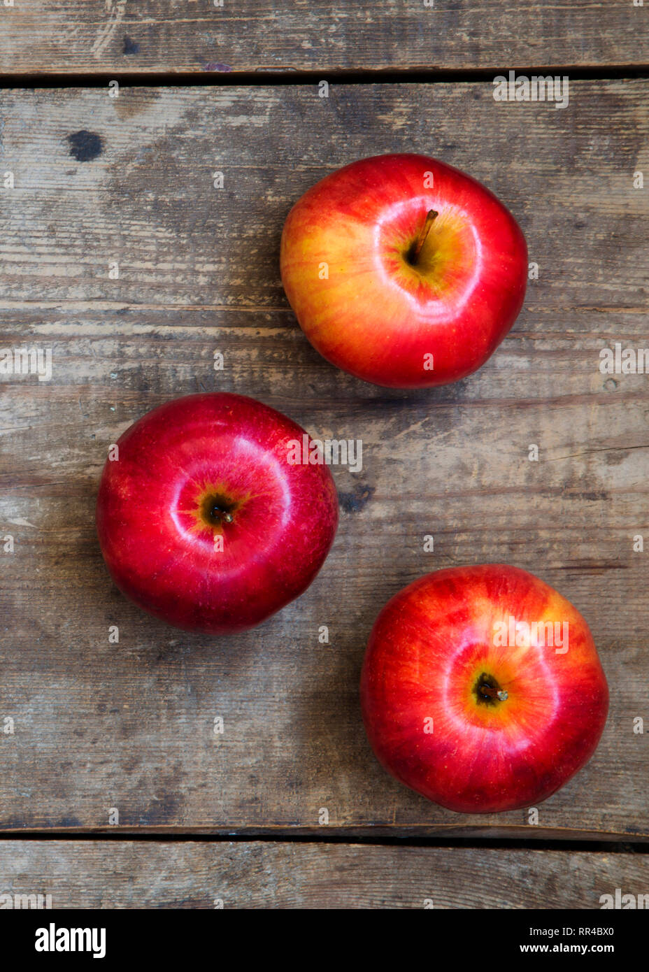 Ripe red apples on dark wooden surface, top view. From above, overhead ...