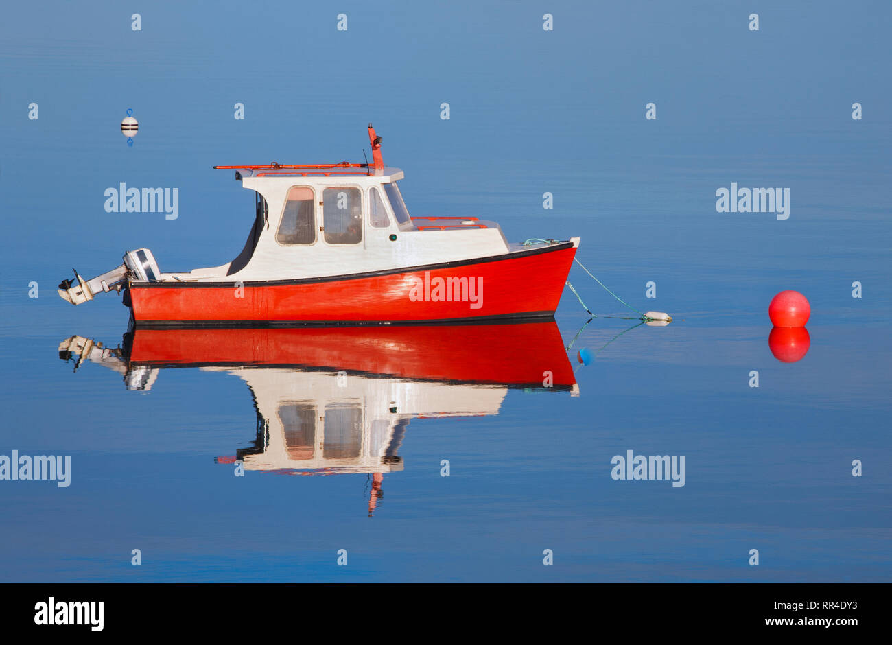 Small wooden boat and buoys in calm blue water Stock Photo - Alamy