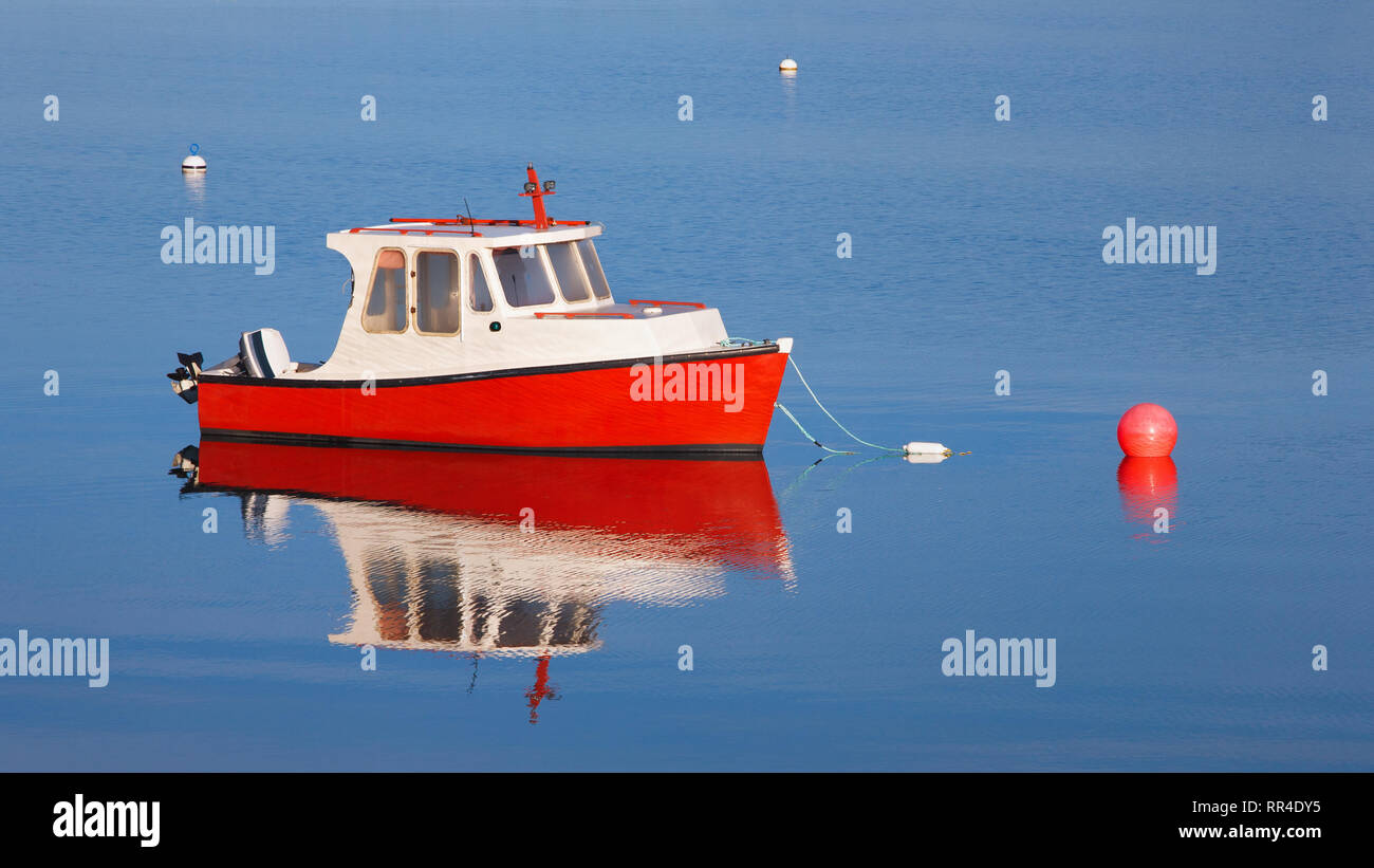 Small wooden boat and buoys in calm blue water Stock Photo - Alamy