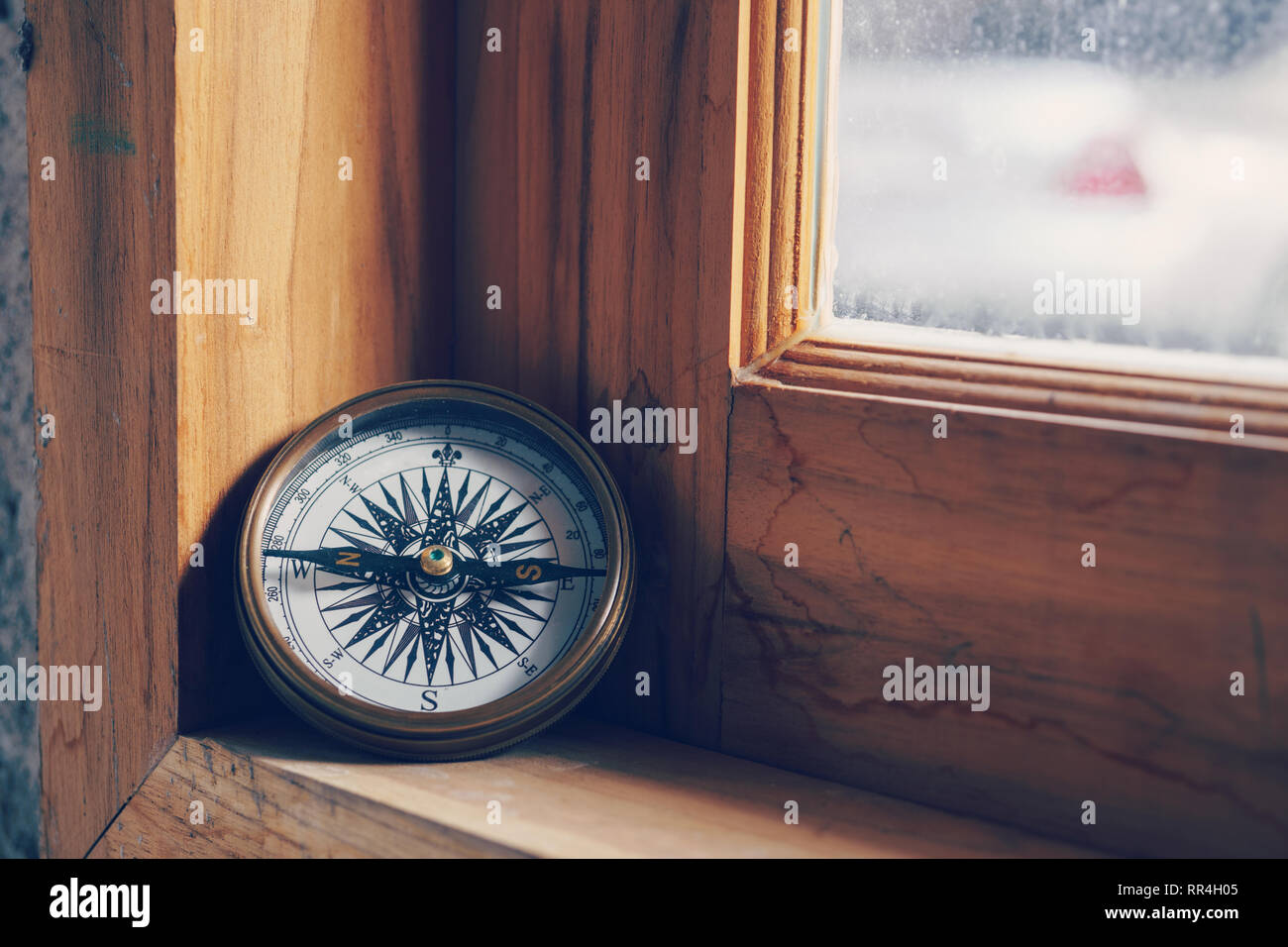 Compass on wooden window for travel and navigation concept Stock Photo ...