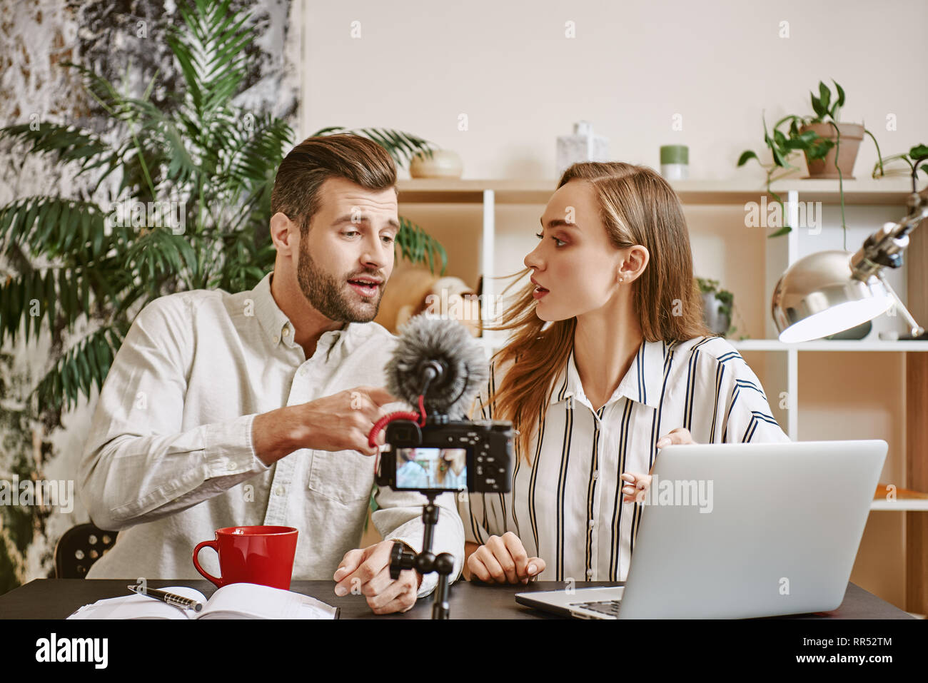 Hot discussion. Emotional male and female bloggers discussing ...