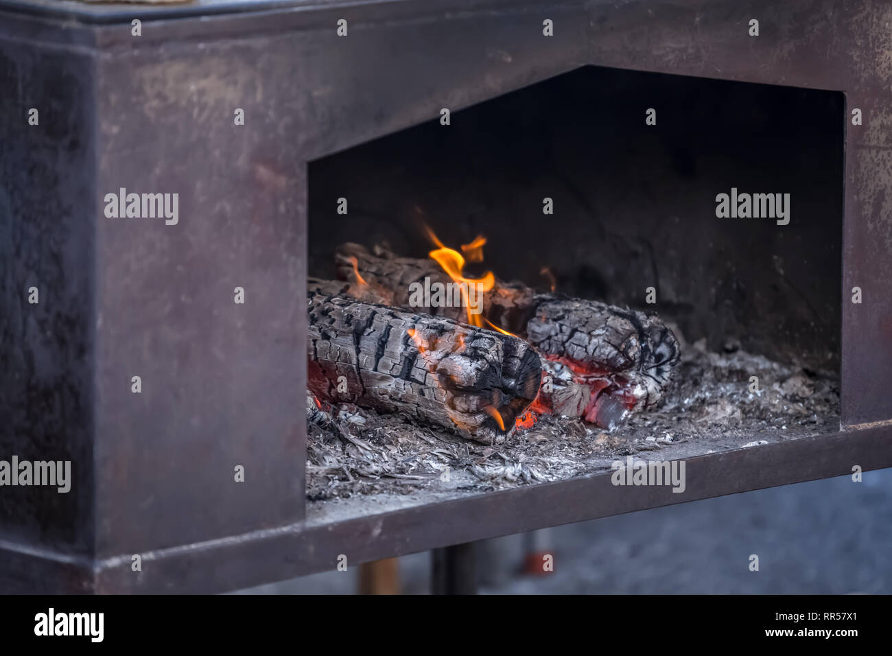 Traditional metal oven view with burning wood Stock Photo - Alamy