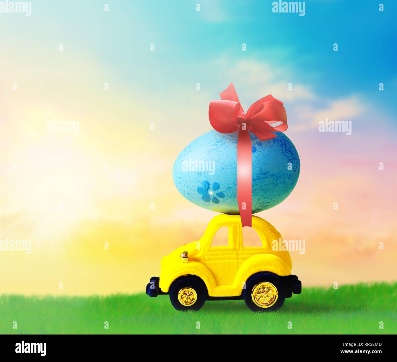Retro toy car with Easter egg on the roof. on spring background Easter ...