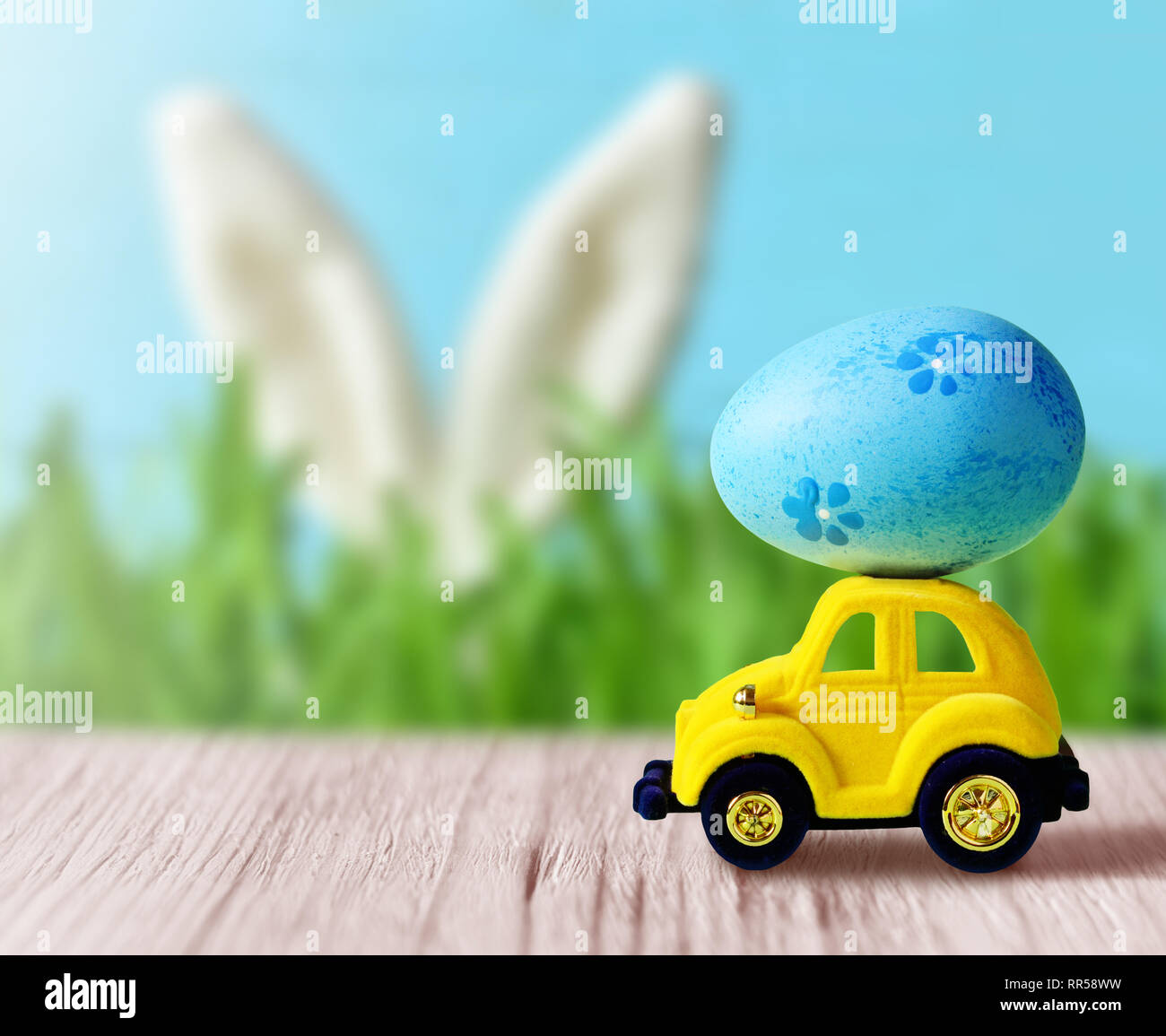 Retro toy car with Easter egg on the roof. on spring background Easter ...