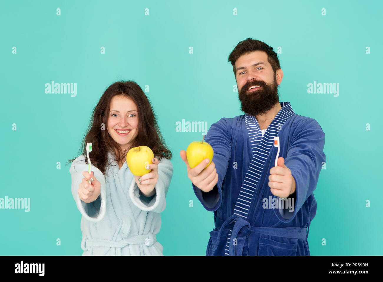 Brush teeth concept. Oral hygiene. Couple in bathrobes hold ...