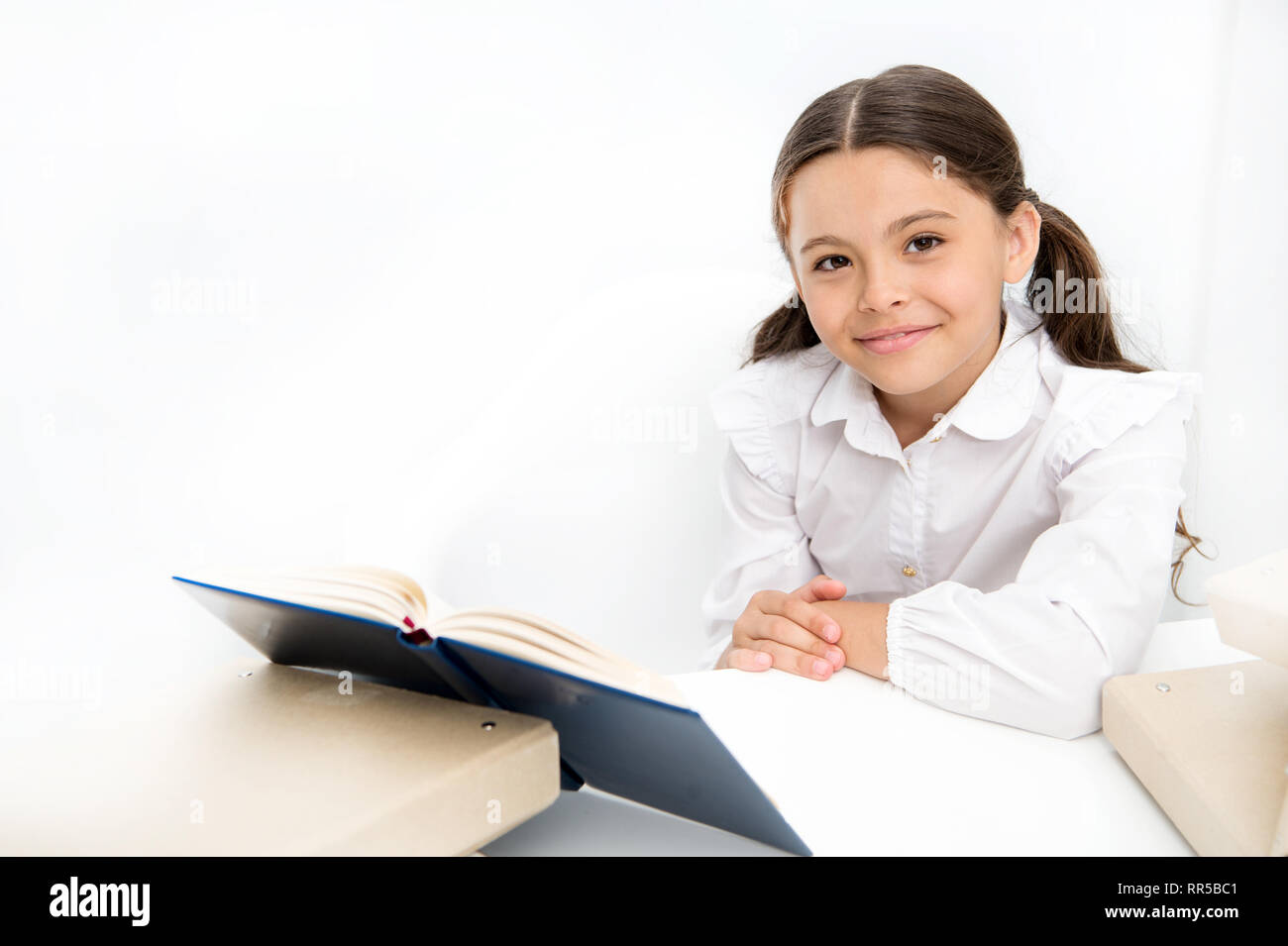 Being smart and cute. Small school child have literature lesson. Little ...