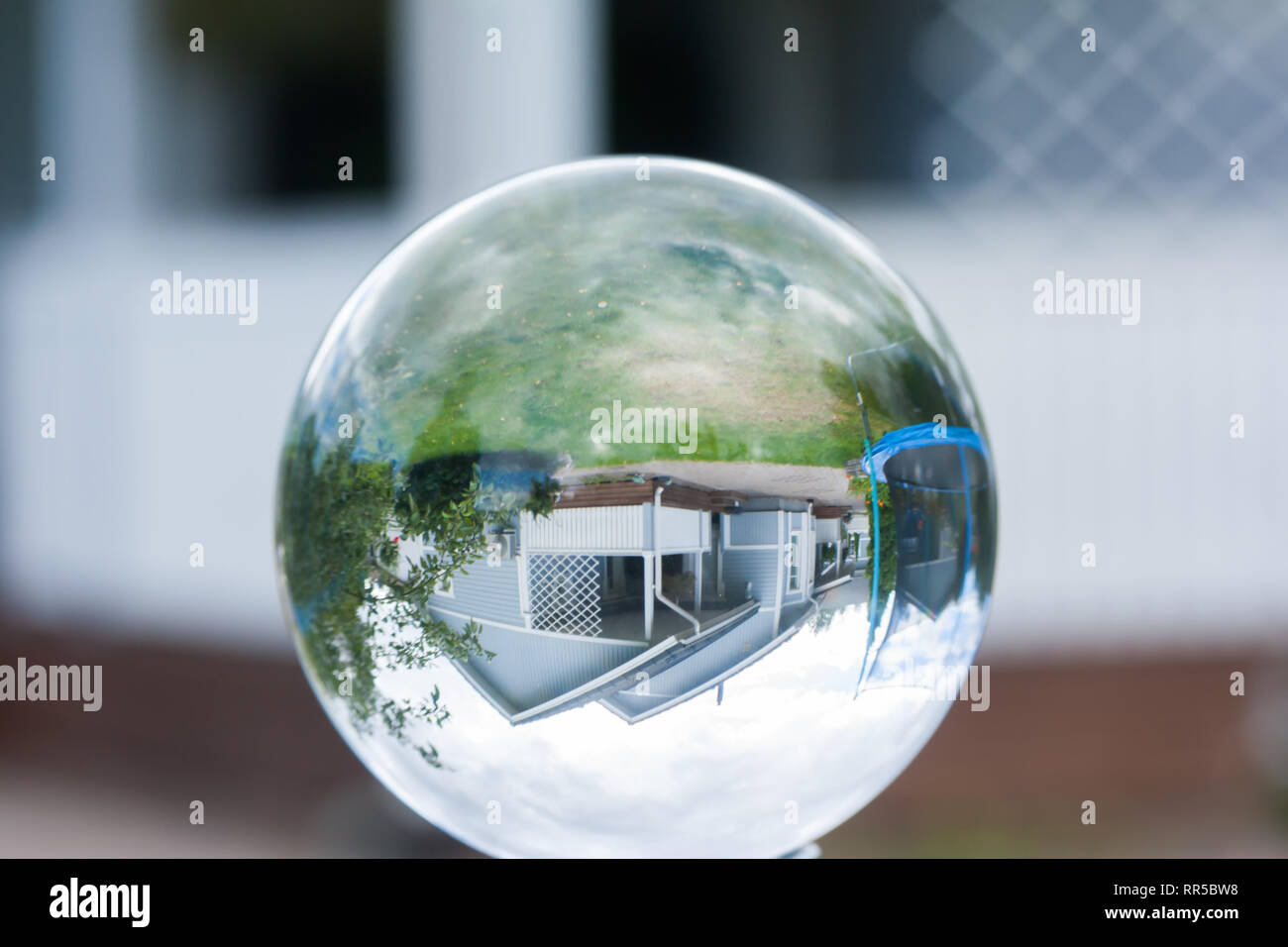 Wooden rural house in a glass ball reflection Stock Photo - Alamy