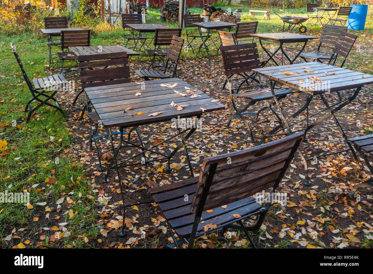 Beautiful autumn in old outdoor cafe in the park - wet tables and ...