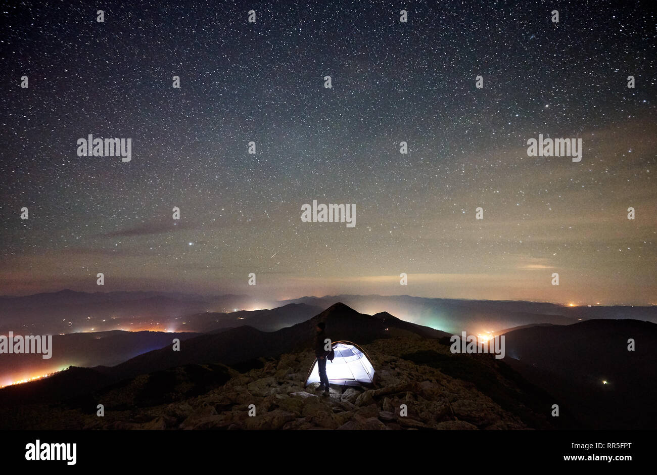 Tourist summer camp at night on the top of the rocky mountain ...