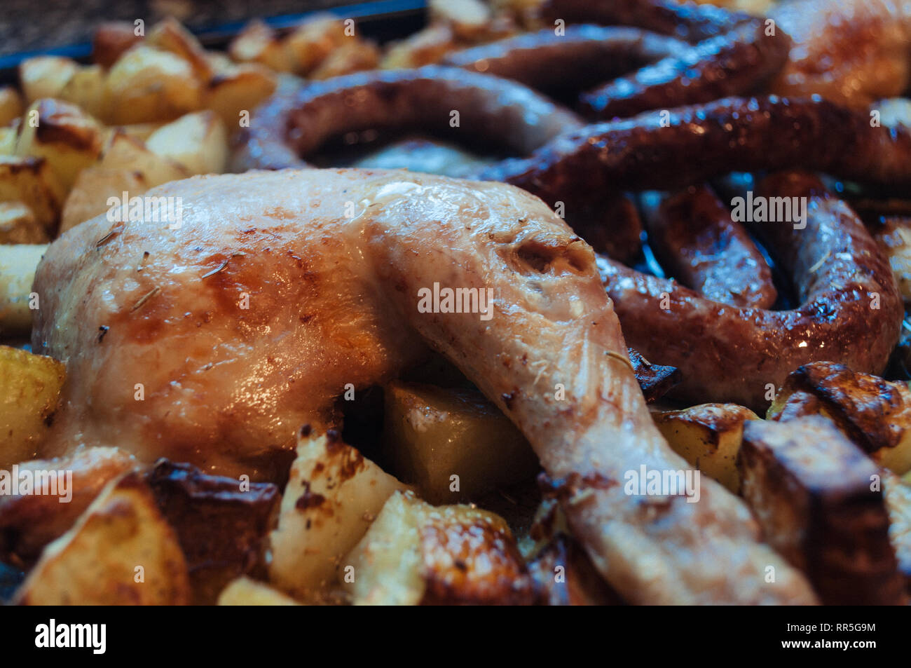 chicken leg, potatoes and sausage Stock Photo - Alamy