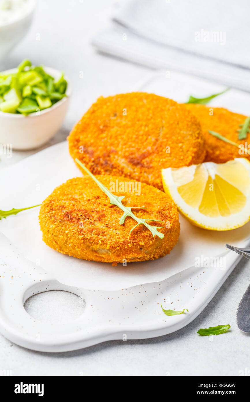 Cooked salmon fish cutlets on a white board Stock Photo - Alamy
