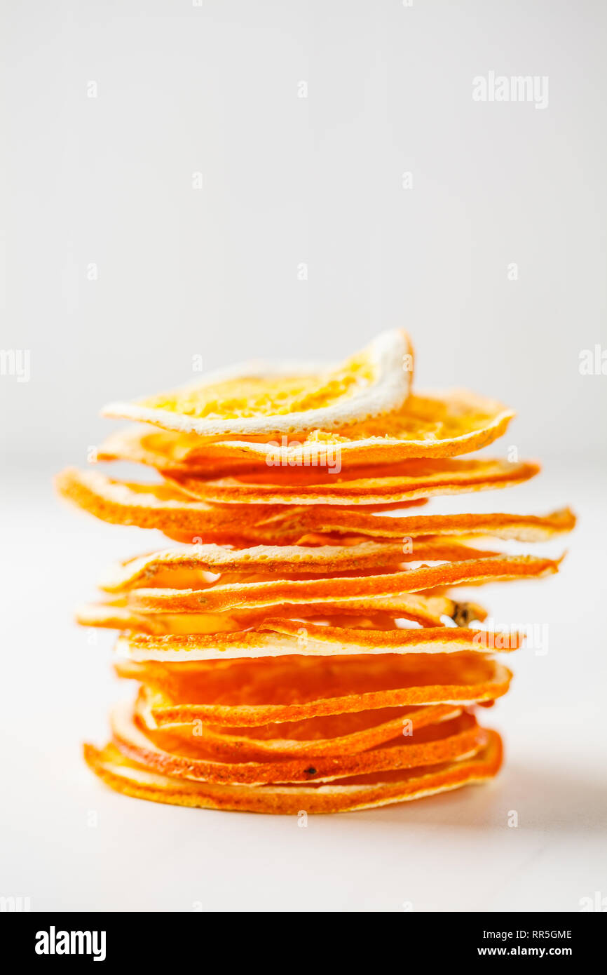 Dried orange chips on a white background Stock Photo - Alamy