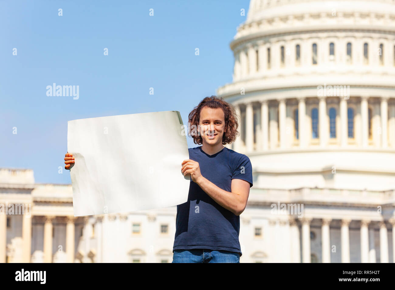 Protester holding blank sign with copy space Stock Photo - Alamy