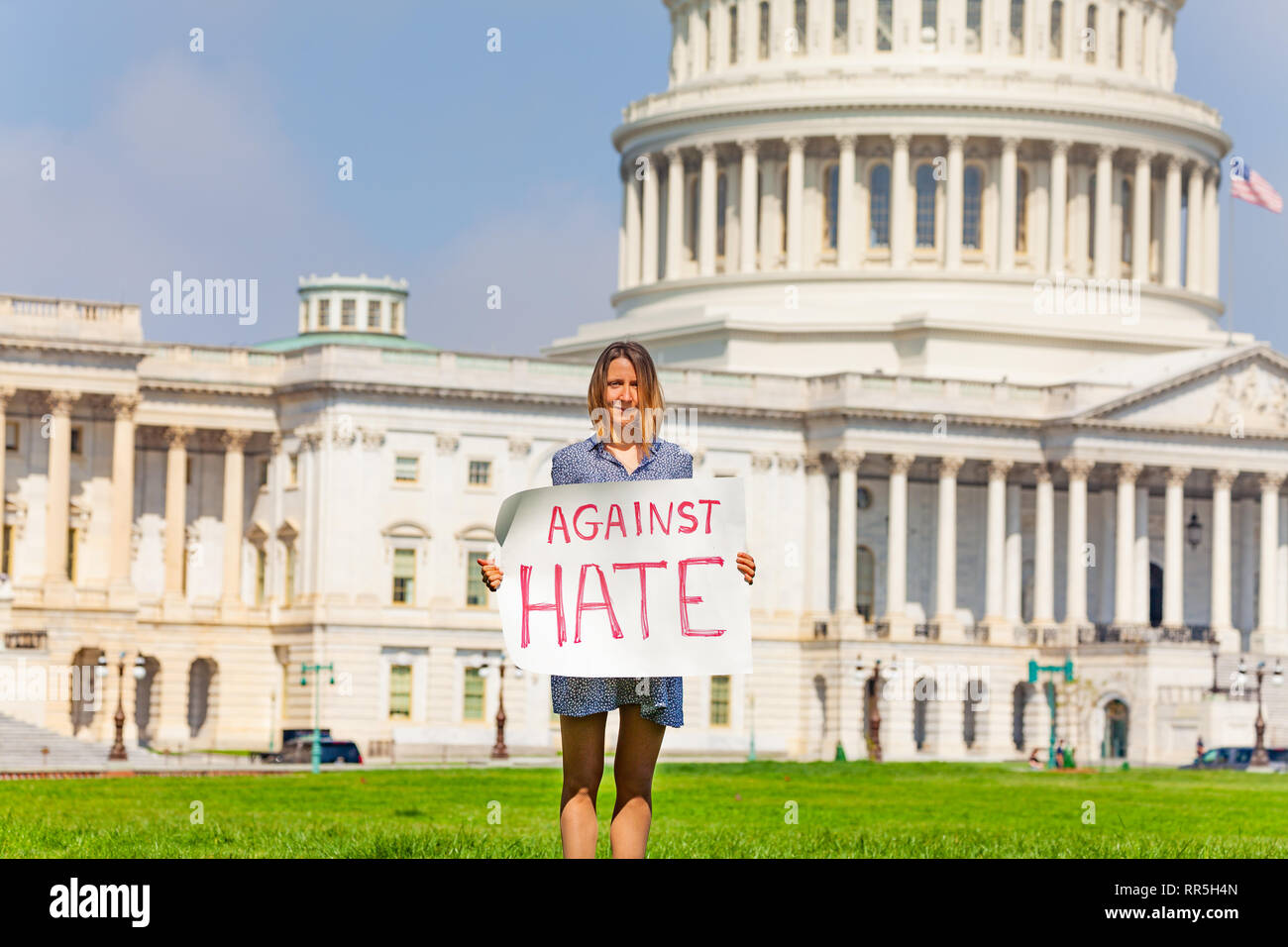 Woman holding sign against racism hi-res stock photography and images ...