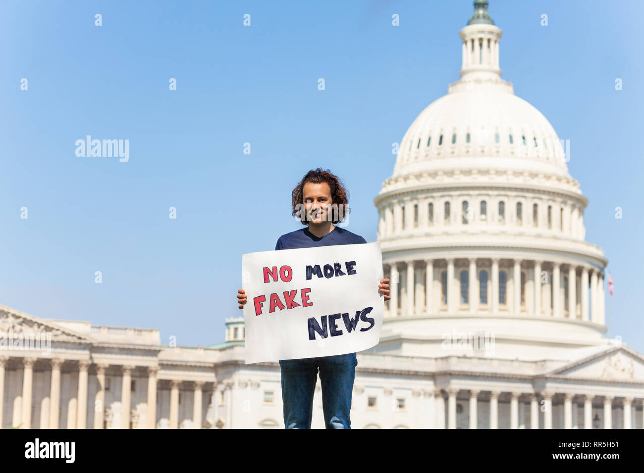 Protester holding sign saying no more fake news Stock Photo - Alamy