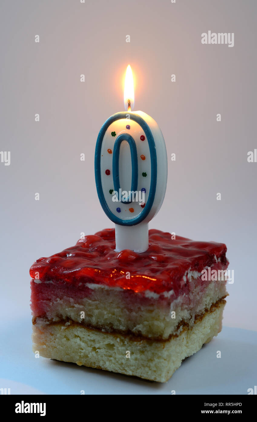 birthday cake with burning zero shaped candle on neutral background ...