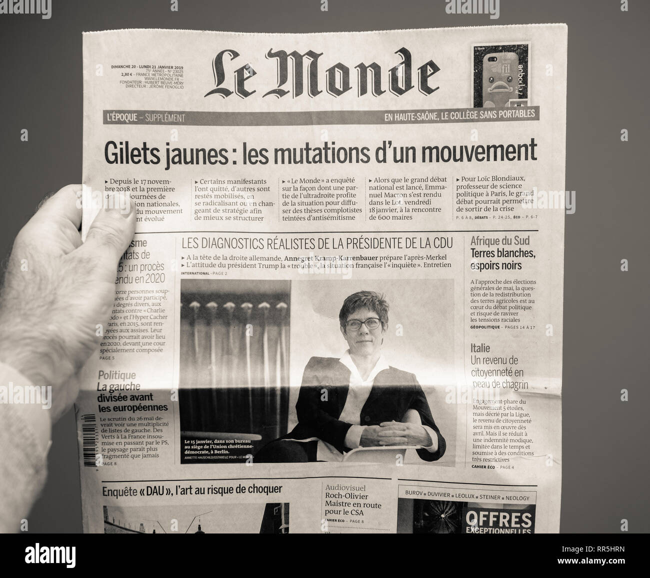 Paris, France - Feb 22, 2019: Man hand holding against gray background ...