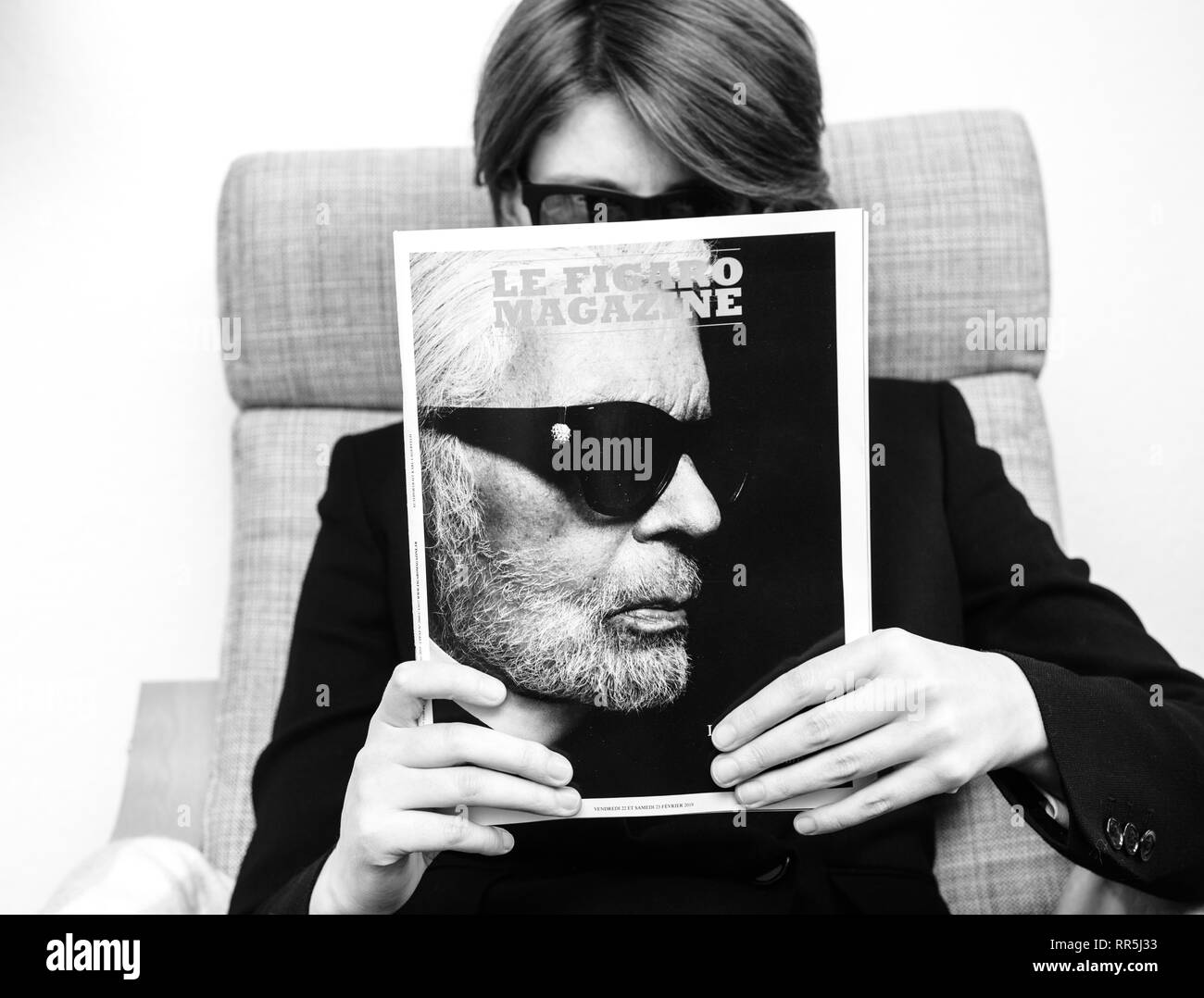 Paris, France - Feb 23, 2019: Woman reading French Le Figaro magazine ...