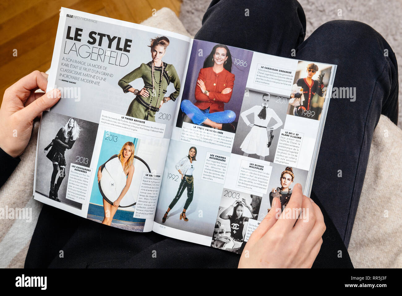 Paris, France - Feb 23, 2019: Woman reading French Elle magazine ...