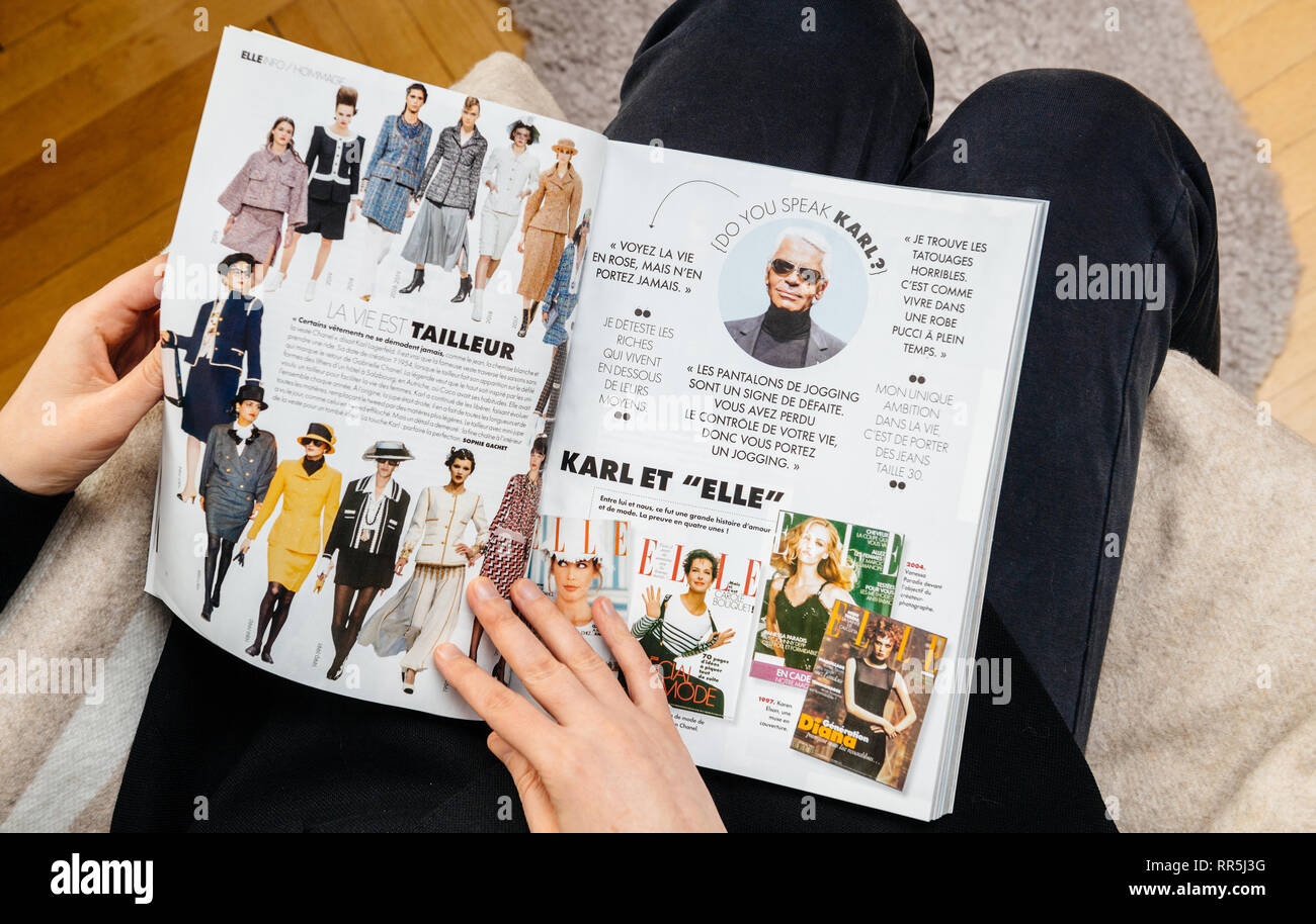 Paris, France - Feb 23, 2019: Woman reading French Elle magazine ...