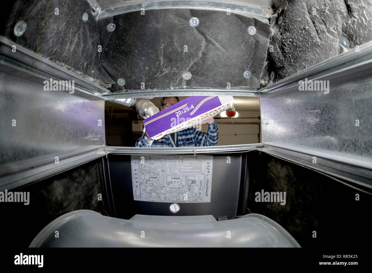 View from inside of a home furnace as a new filter is replaced Stock ...