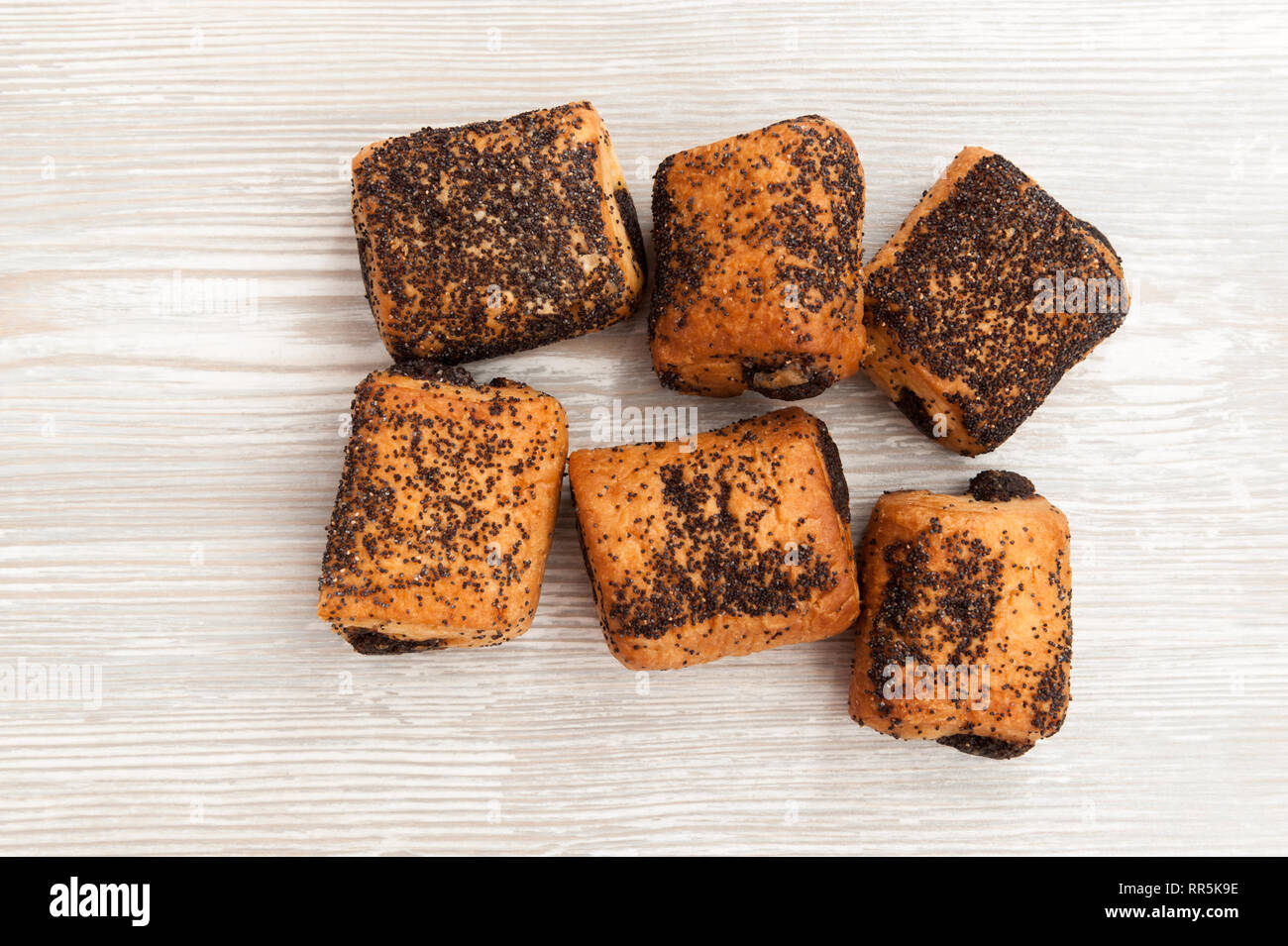 puff with poppy seeds on light wooden background Stock Photo - Alamy