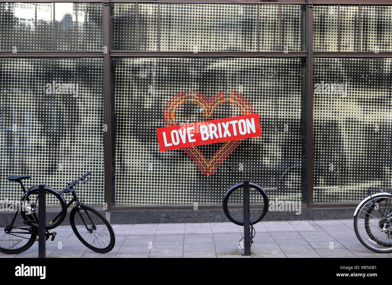 Love Brixton heart sign in a window and bikes on a street in Brixton ...