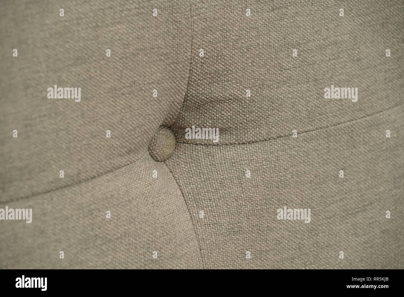 Grey fabric sofa, close up detail with buttons Stock Photo - Alamy
