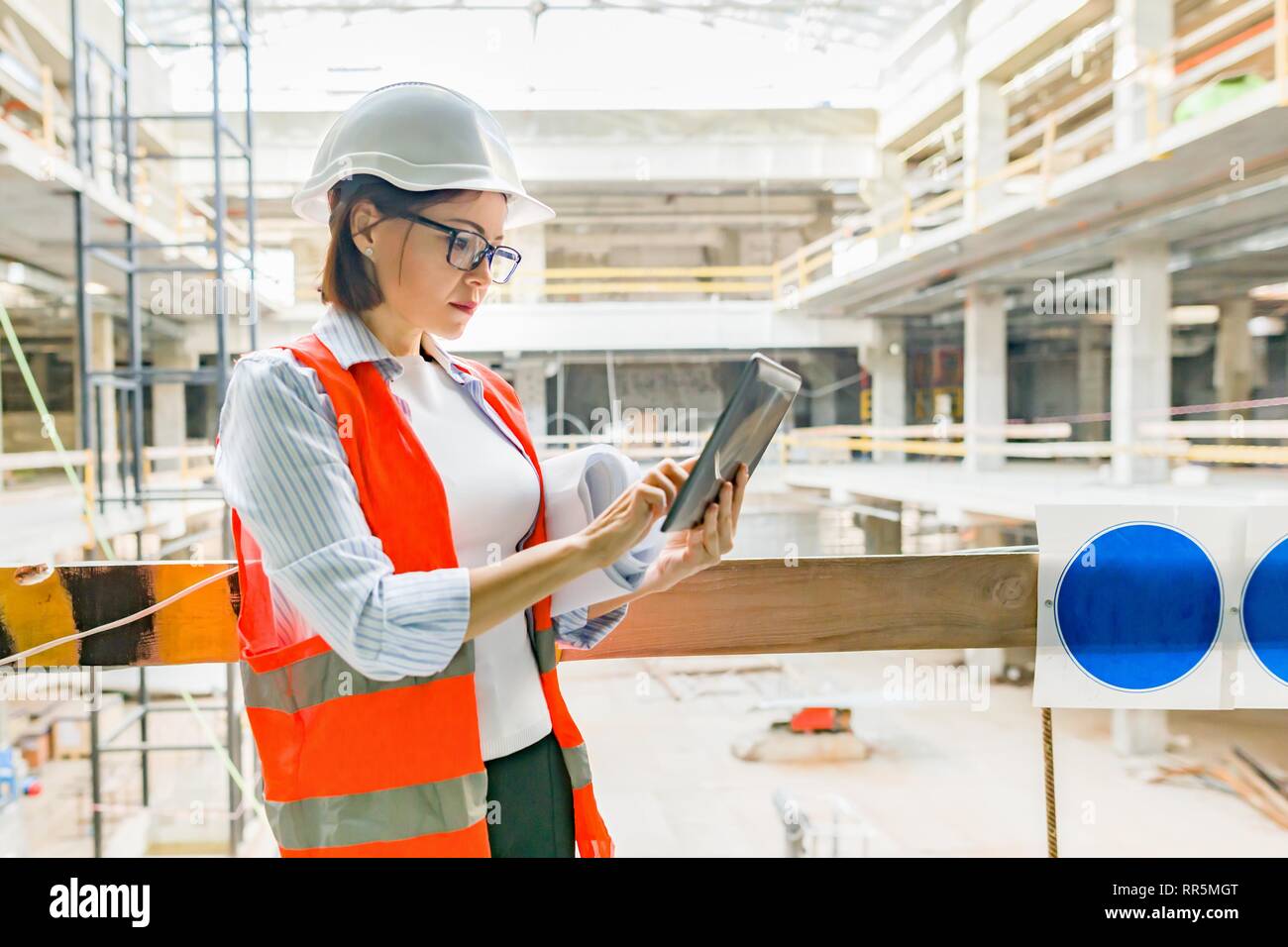 Portrait of adult female builder, engineer, architect, inspector ...
