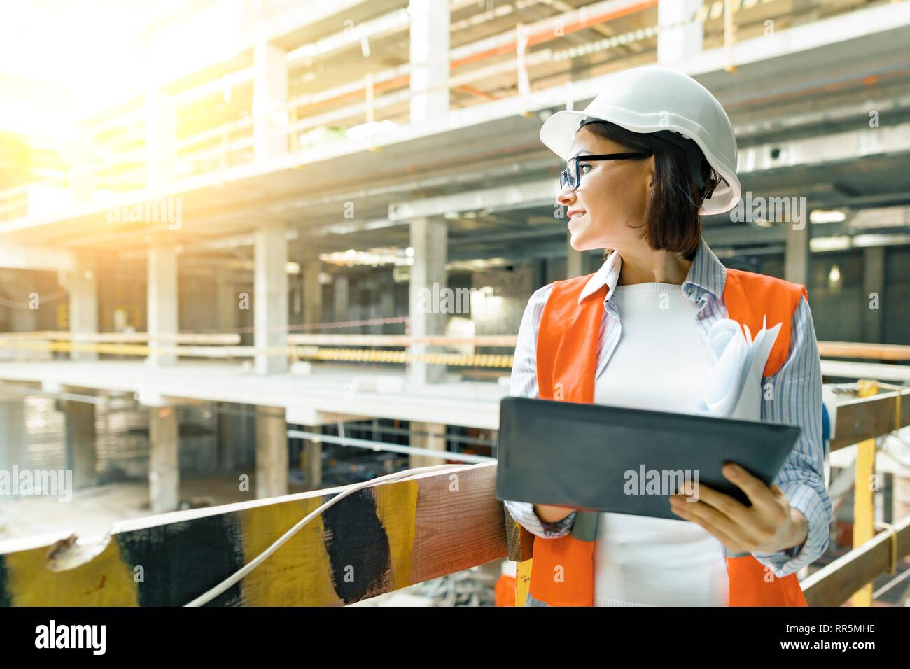Portrait of adult female builder, engineer, architect, inspector ...