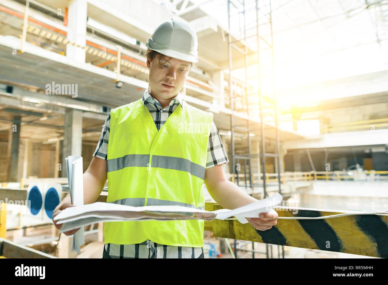 Portrait of confident male builder, manager, engineer with building ...