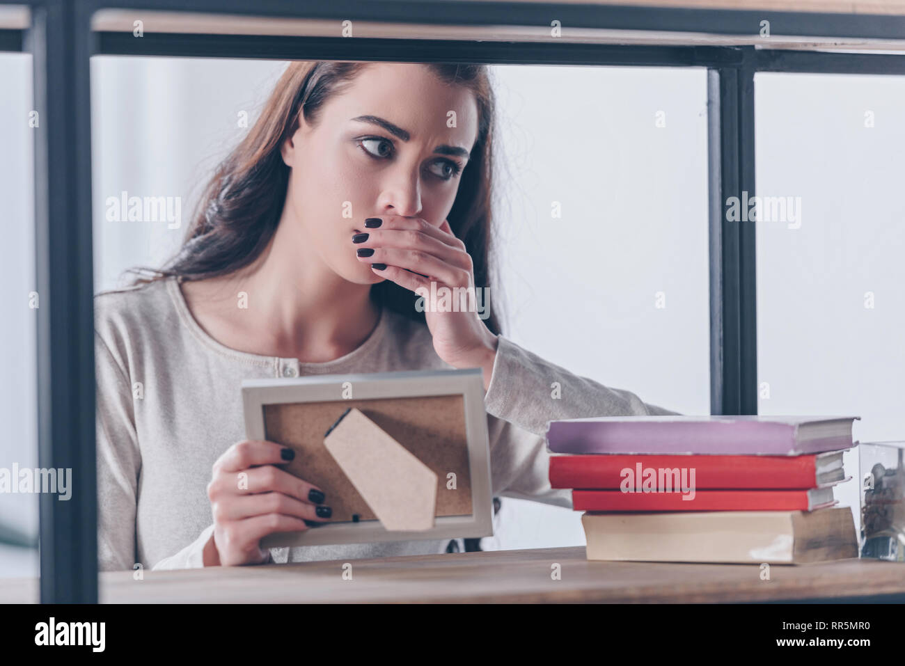 Woman covering mouth with hand hi-res stock photography and images - Alamy